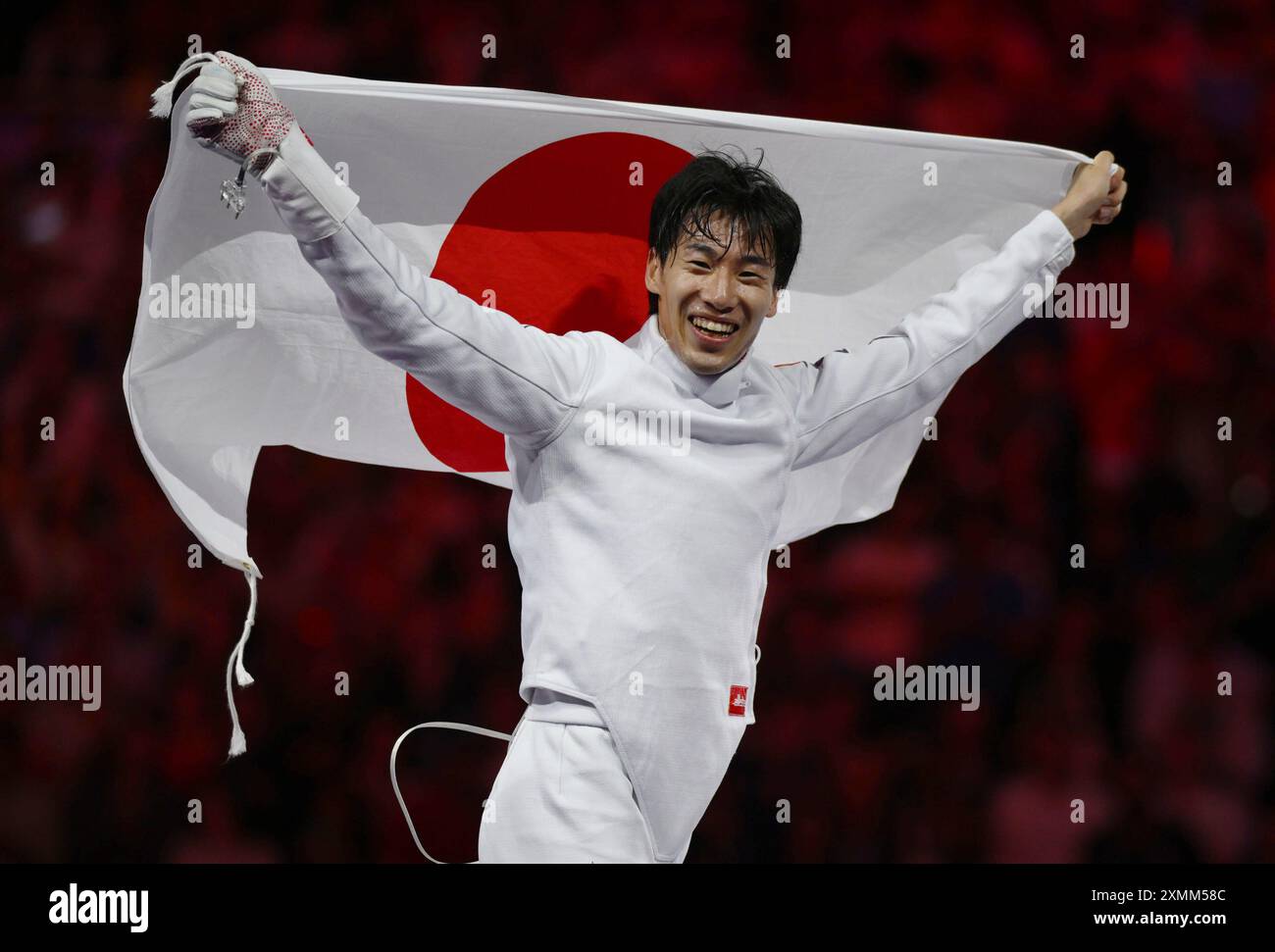 Koki Kano of Japan celebrates with the Japanese flag after winning in ...