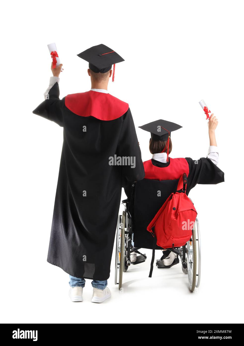 Female graduate in wheelchair and her classmate with diplomas on white ...