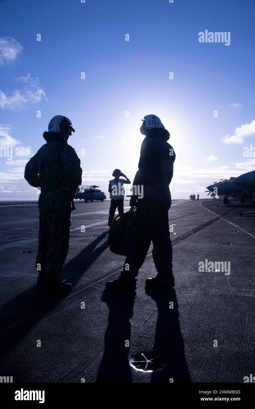 Rear Adm. Michael Wosje, right, commander, Carrier Strike Group ONE ...