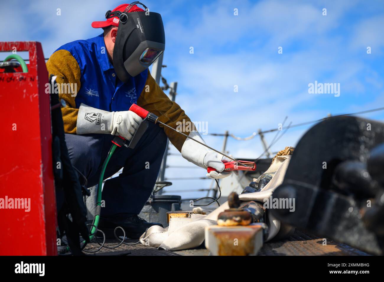 Damage Controlman 1st Class Richard Becan prepares to cut a part of the ...