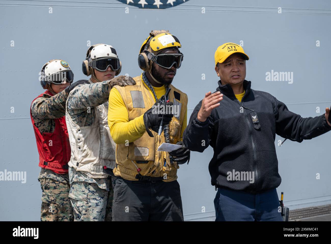 Aviation Boatswain’s Mate (Handling) 1st Class Reyvin Olaes (right), a Cavite, Philippines ...