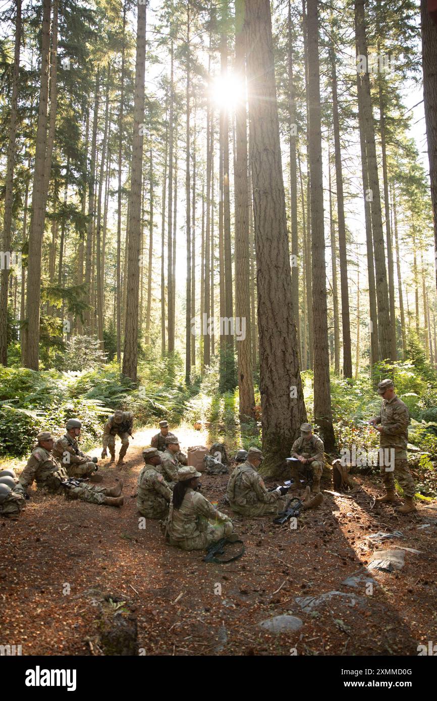 U.S. Army Officer Candidates receive instructions to navigate obstacles ...