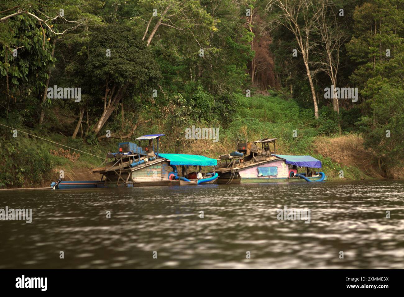 River boats equipped with sluice box to mine gold on Manday river in ...