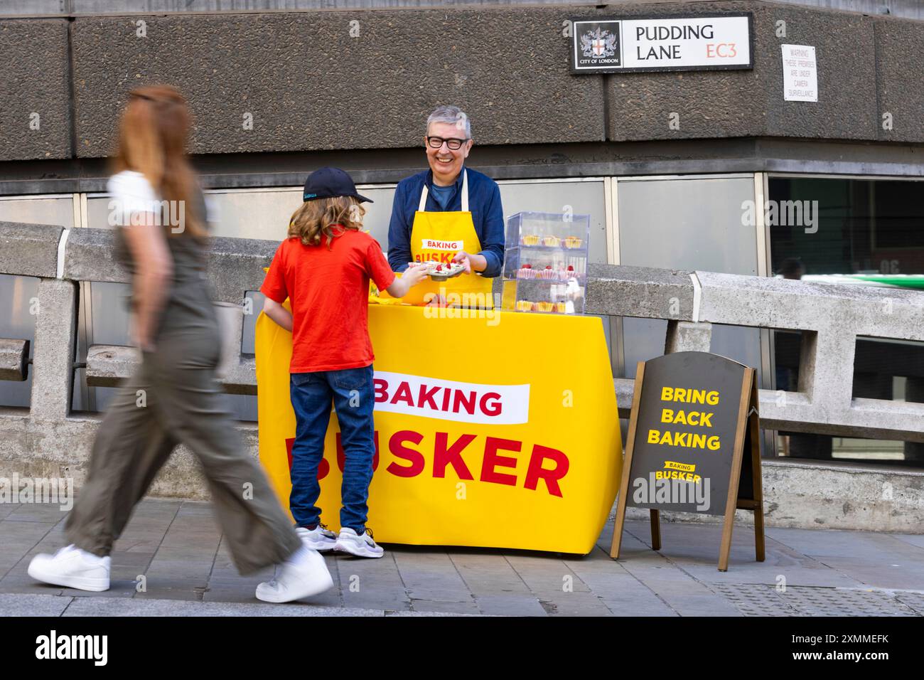 EDITORIAL USE ONLY Samuel Hopper-Reeve aged 9 takes a cake from former ...