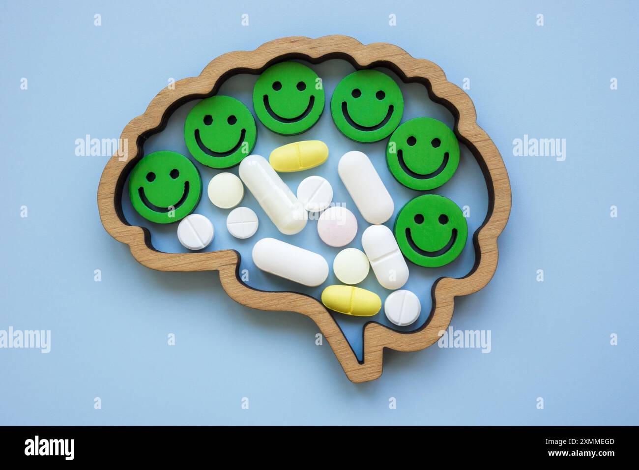 Brain with happy smileys and antidepressant pills or for the treatment ...