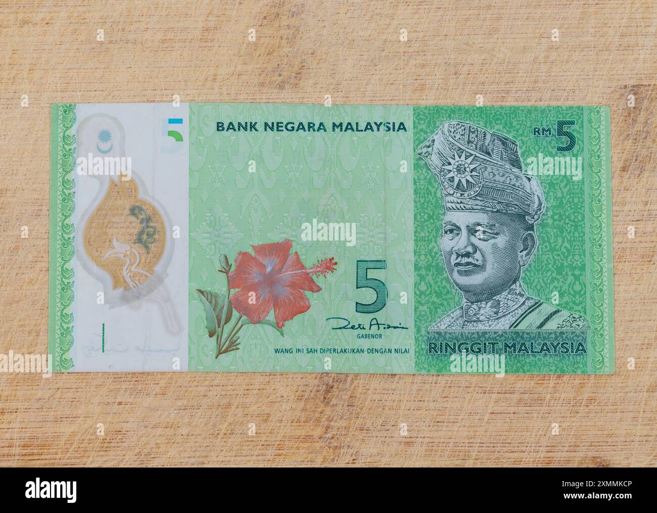 Malaysian five ringgit polymer banknote on a wooden background Stock ...