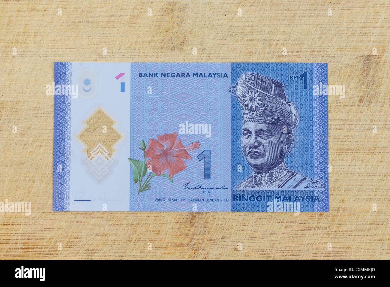 Malaysian one ringgit banknote on a wooden background Stock Photo - Alamy