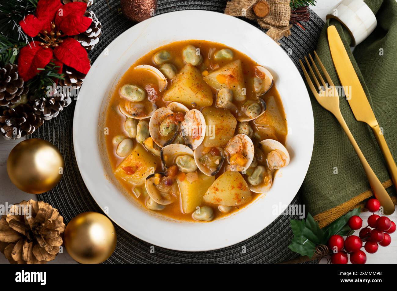 Clam stew with potatoes and beans. Traditional Spanish recipe served on ...