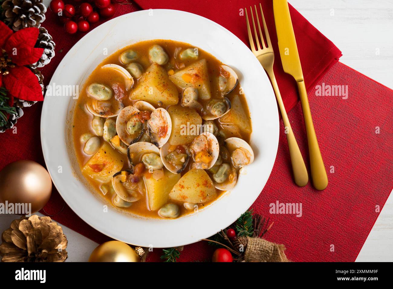 Clam stew with potatoes and beans. Traditional Spanish recipe served on ...