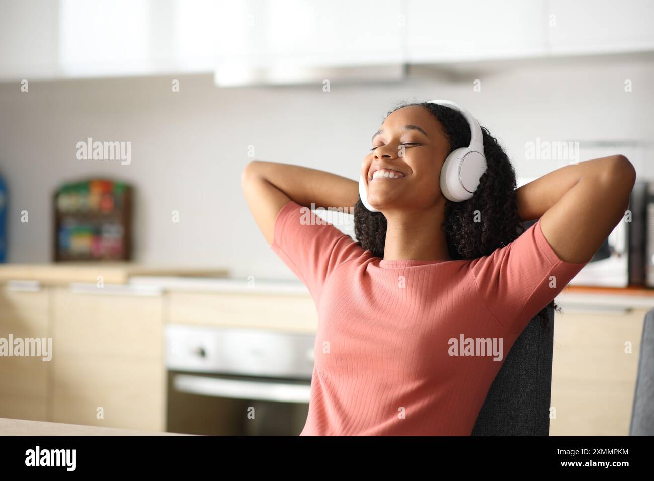 Happy black woman relaxing listening audio with headphone in the ...