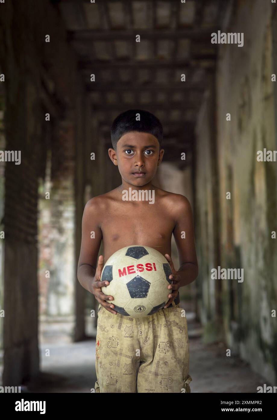Bangladeshi boy with a Messi ball in Pakutia Zamindar Bari, Dhaka ...