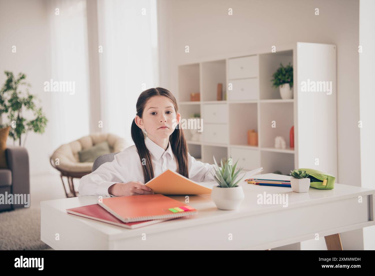 Photo portrait of cute small schoolgirl tired read textbook homework ...