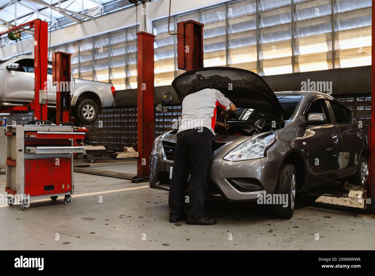 Car Maintenance Technician Working on Engine Stock Photo - Alamy