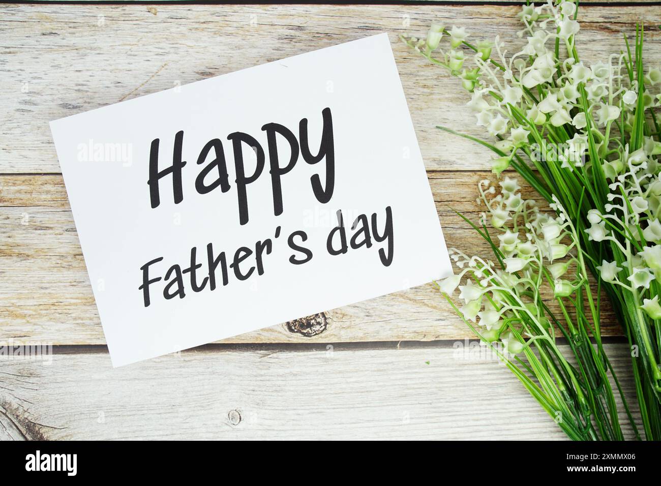 Happy Father's Day text on paper card with flowers bouquet top view on ...