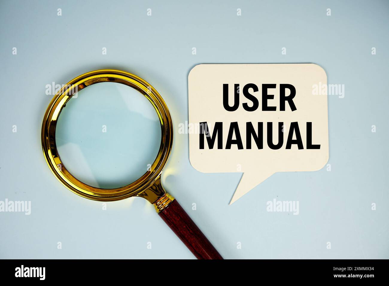 User Manual text on speech bluble with magnifying glass top view on ...