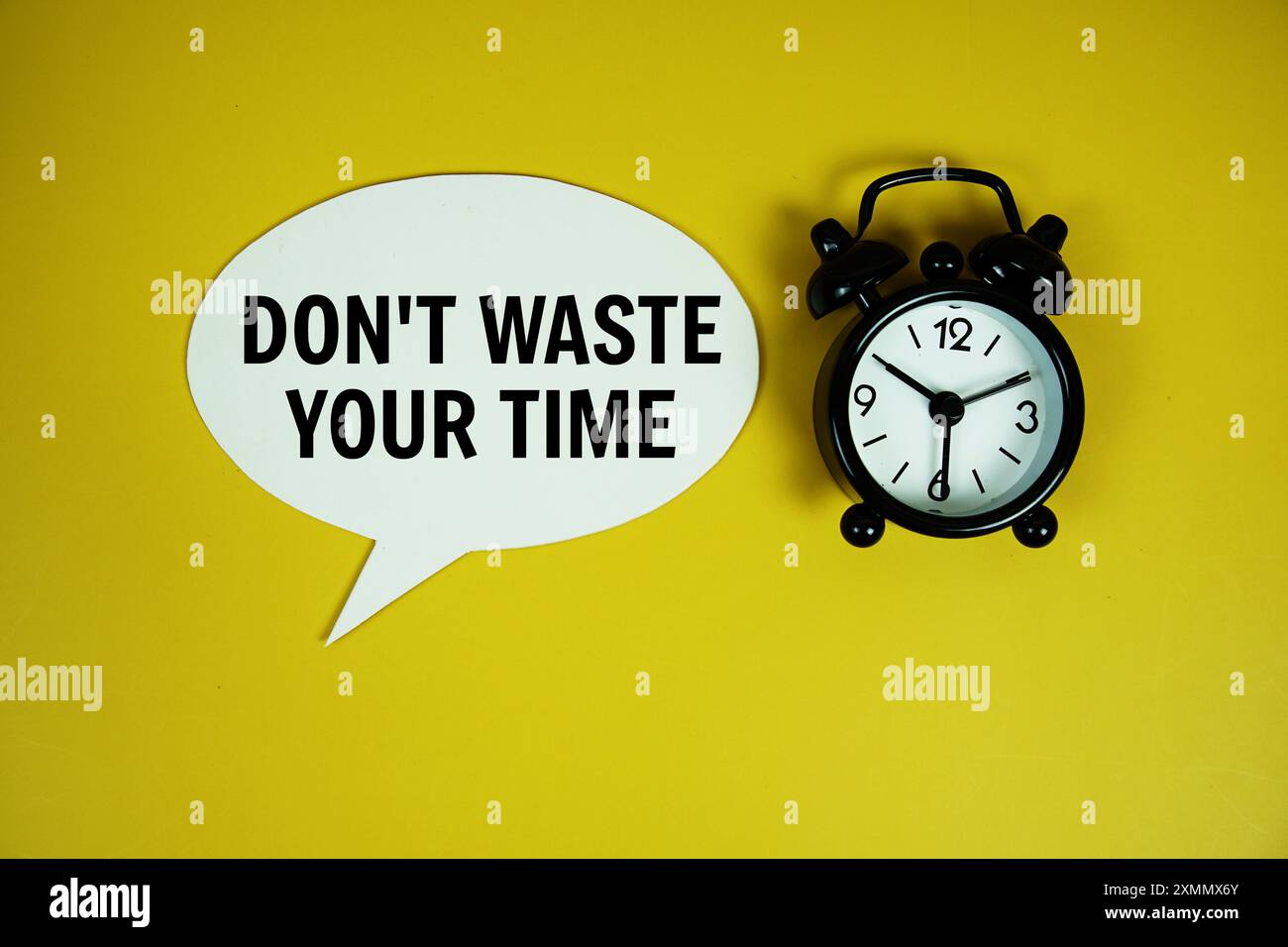 Don't waste your time text on speech bluble with alarm clock top view ...