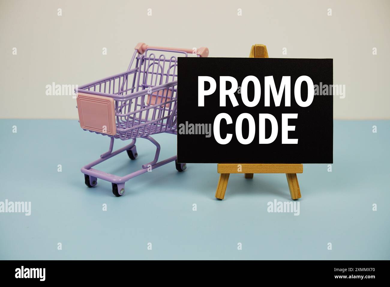 Promo code text message and trolley shopping cart on blue background ...