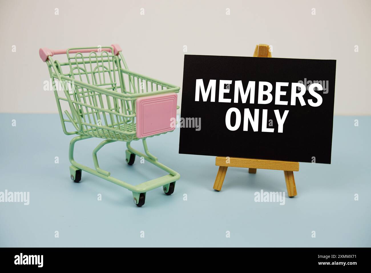 Members Only text message and trolley shopping cart on blue background ...