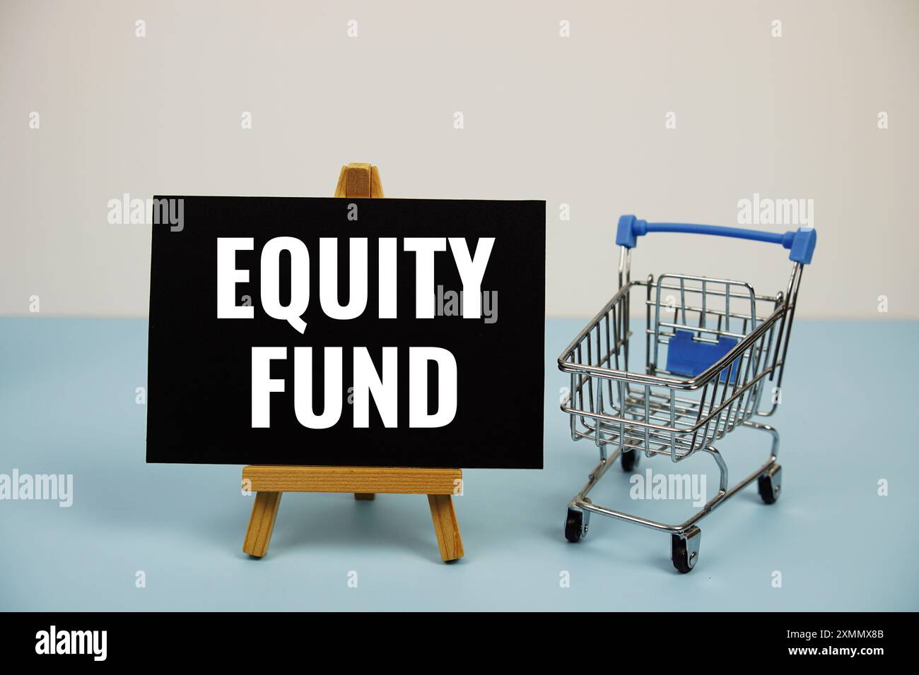 Equity Fund text message and trolley shopping cart on blue background ...