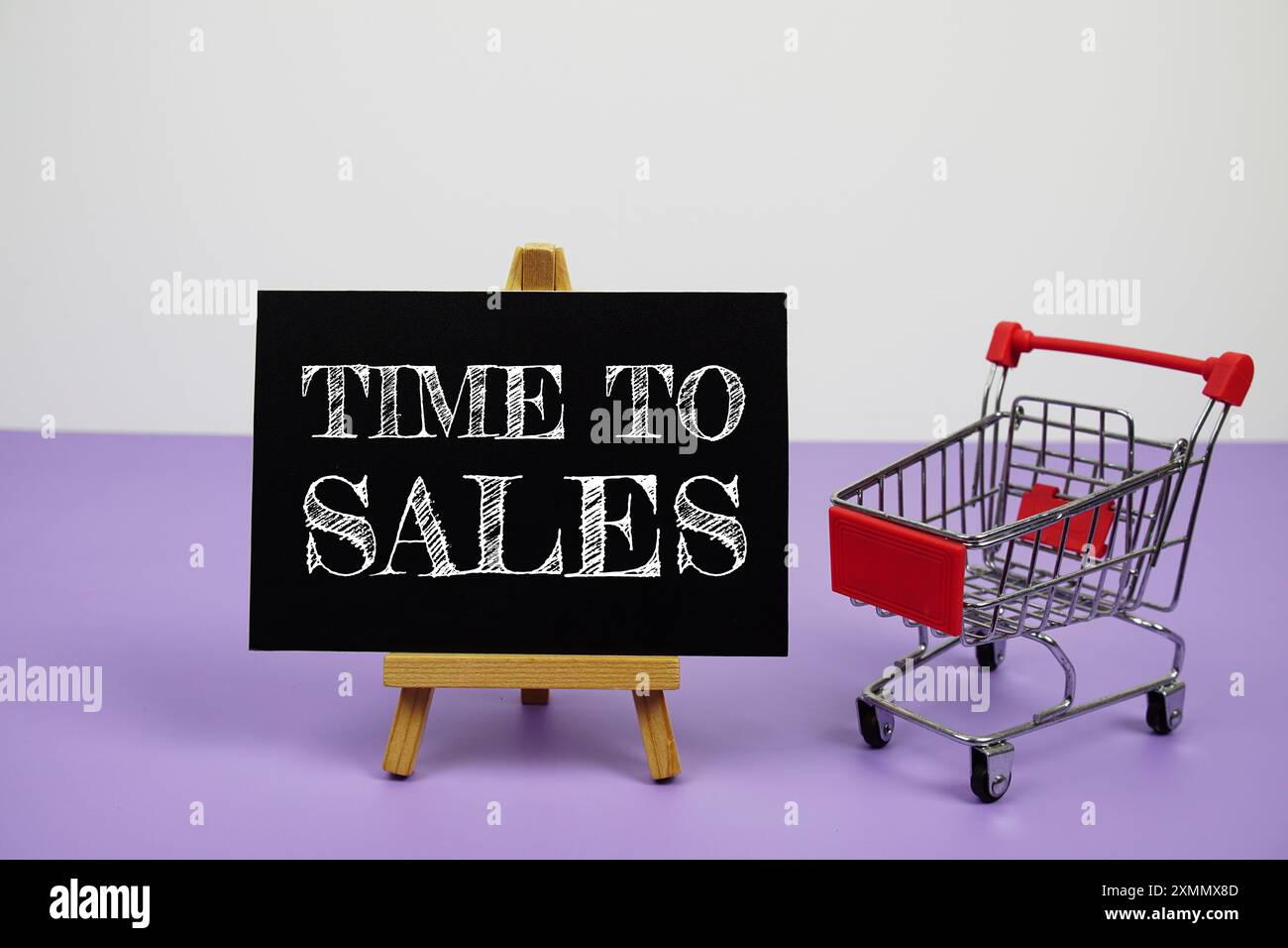 Time to Sales text message and trolley shopping cart on purple ...