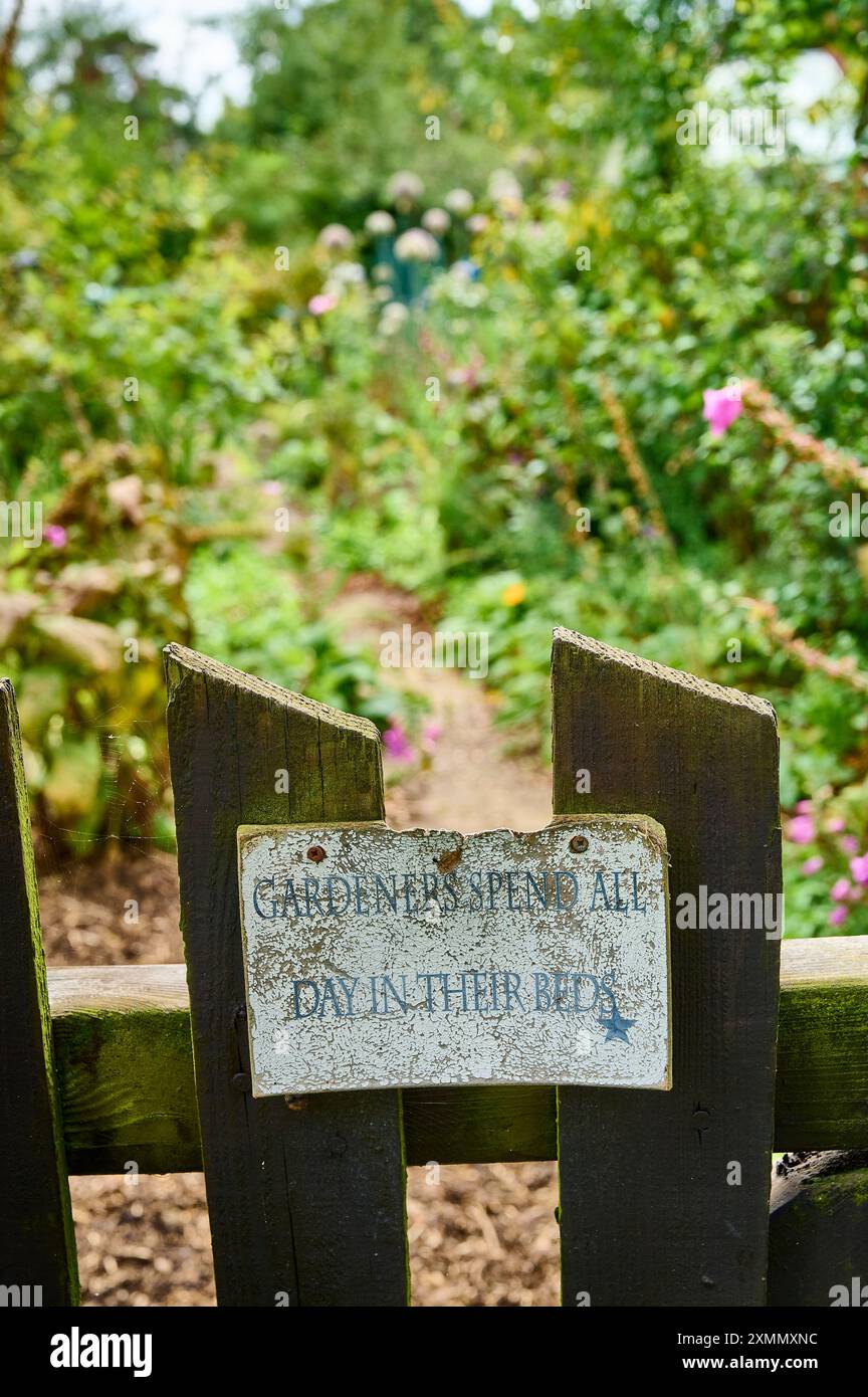 Sign on allotment gate in St Michael's village,"gardners spend all day ...