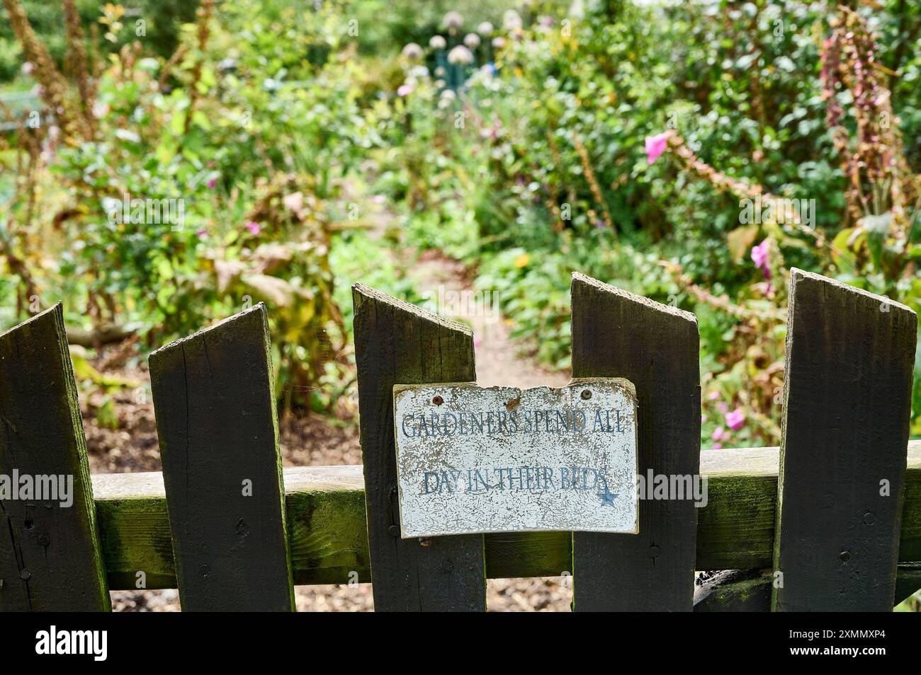 Sign on allotment gate in St Michael's village,"gardners spend all day ...