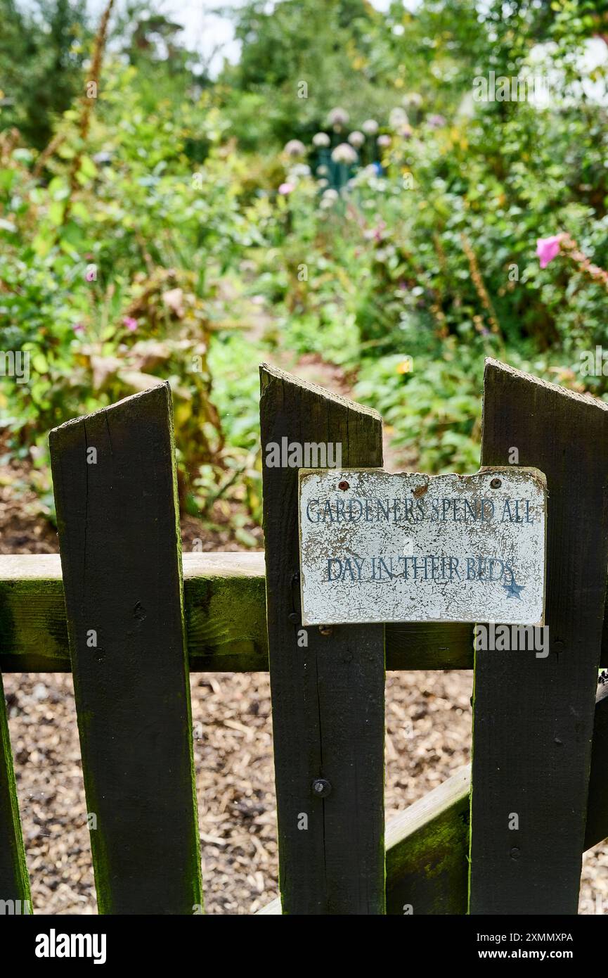 Sign on allotment gate in St Michael's village,"gardners spend all day ...
