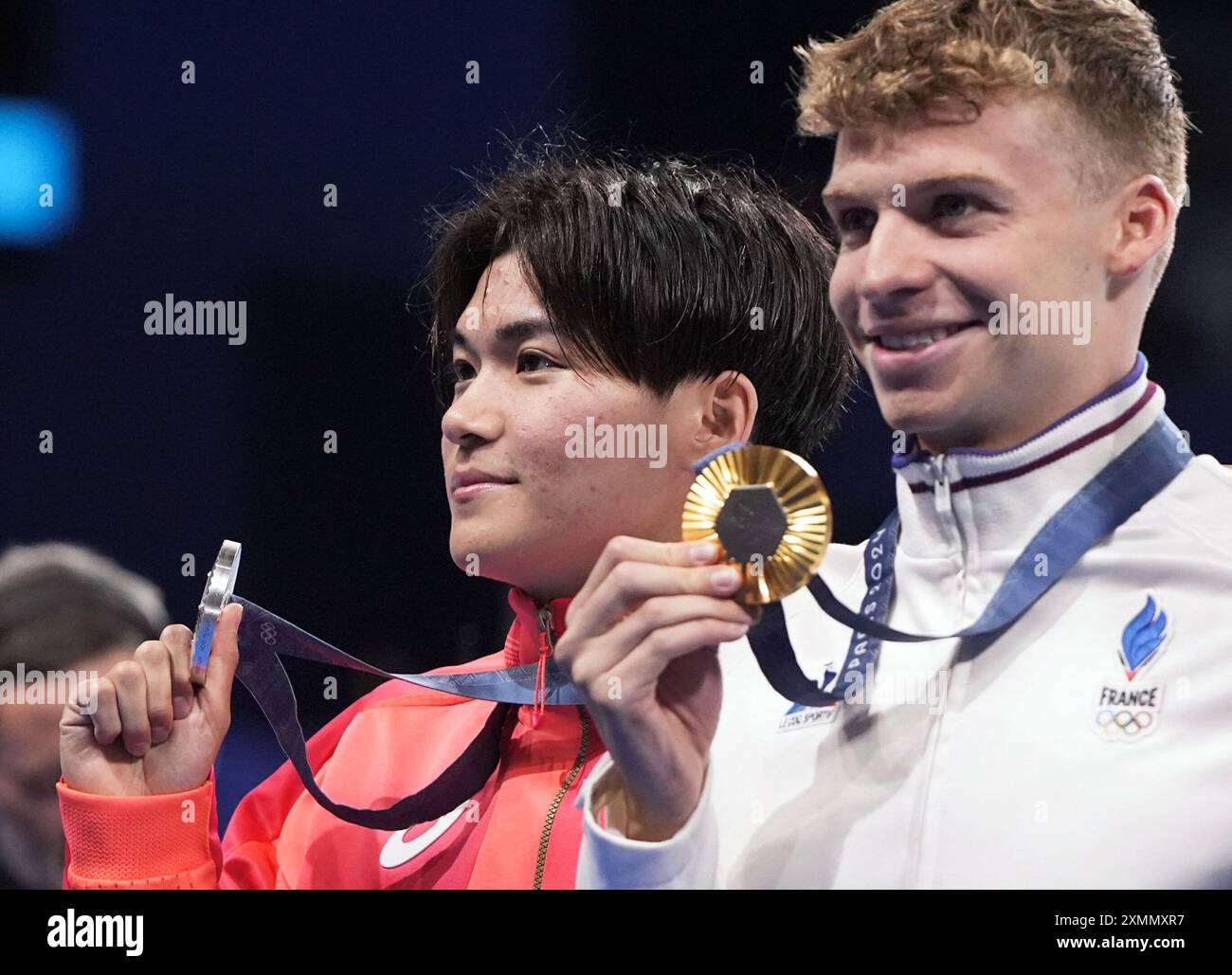 French swimmer Leon Marchand (R) poses for photos after winning the men ...