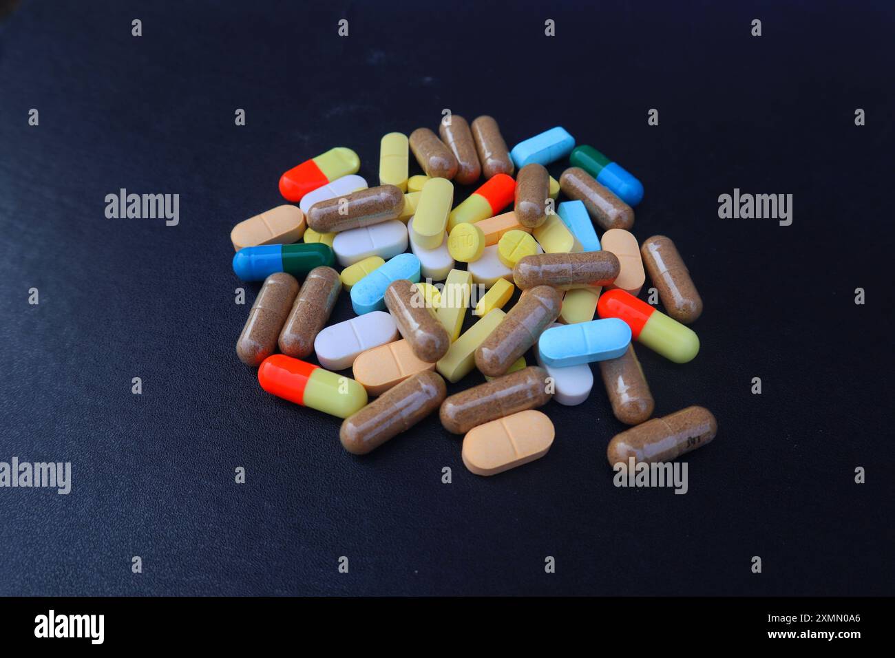 Various kinds of medicine tablets, capsules and caplets mixed in close ...