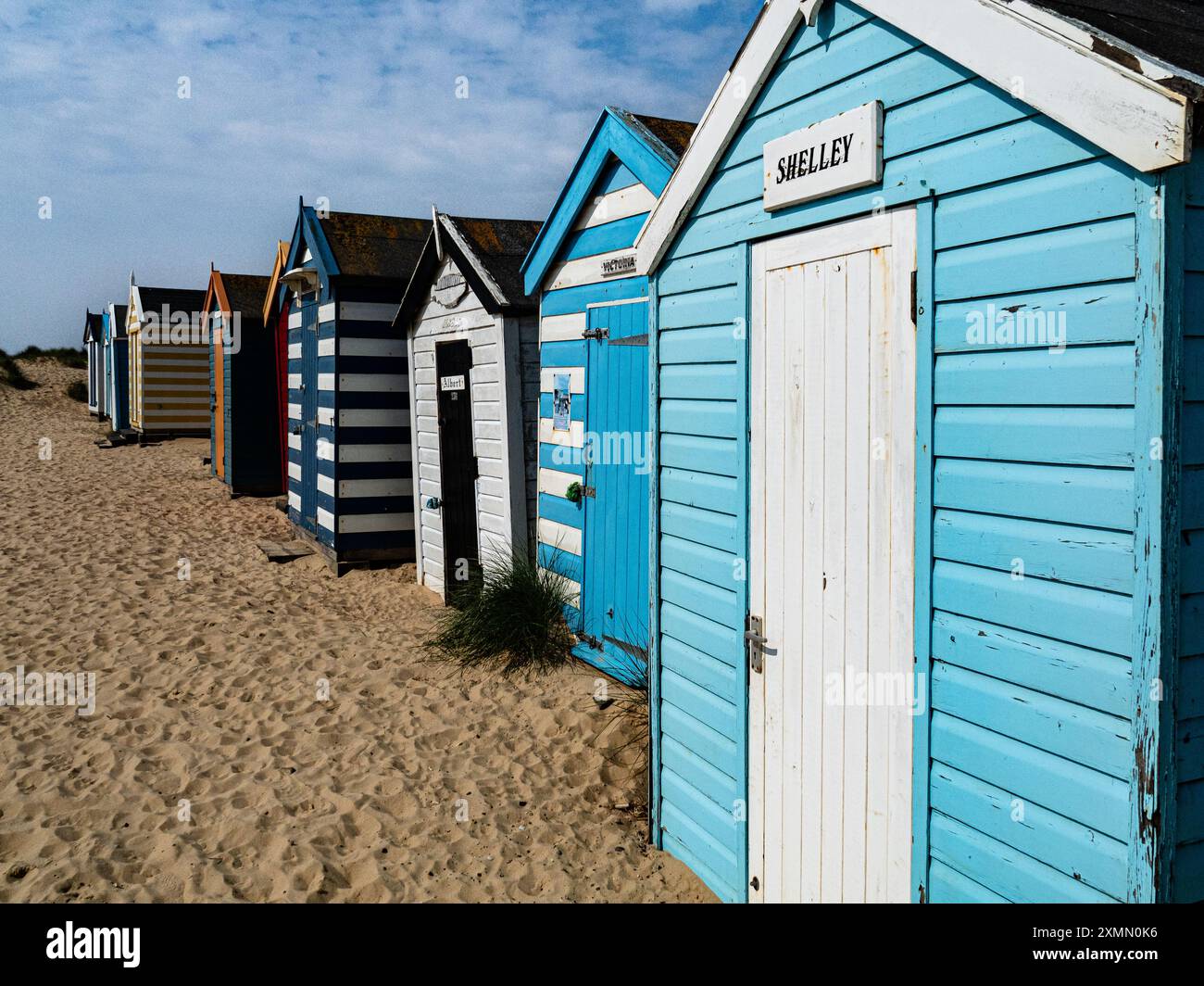 The iconic multi coloured beach huts along the sea front in Southwold ...