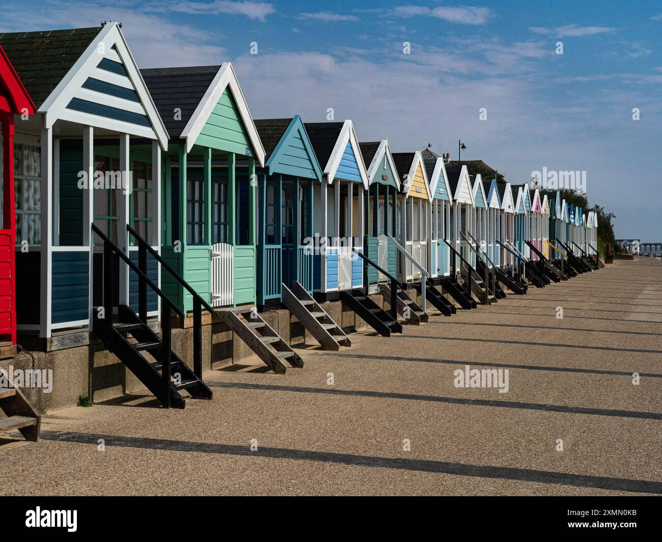 The iconic multi coloured beach huts along the sea front in Southwold ...
