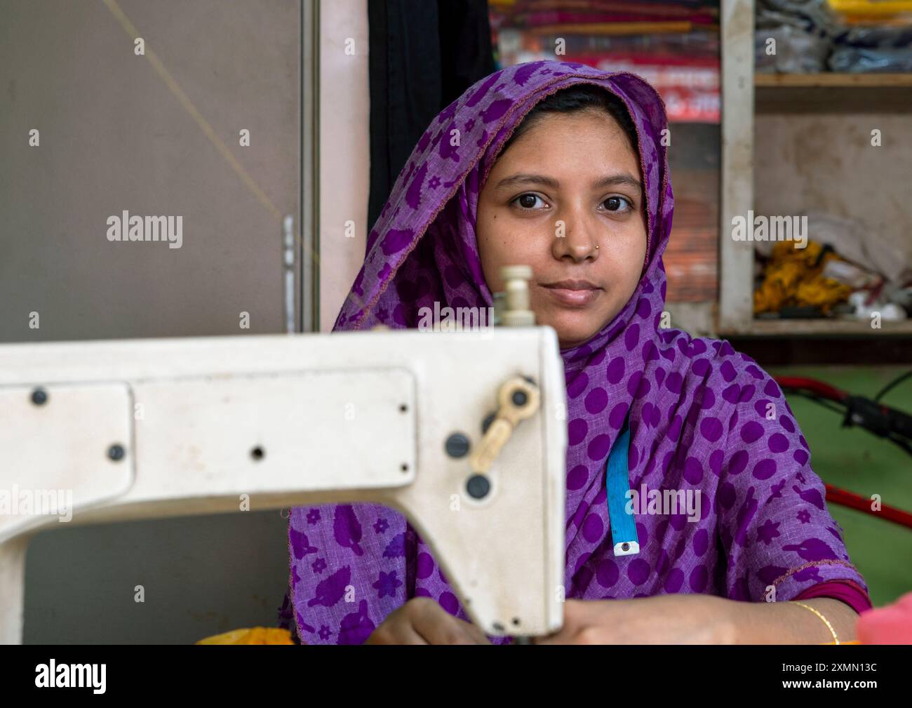 Teenage girl working on a sewing machine in Korail slum, Dhaka Division, Dhaka, Bangladesh Stock ...