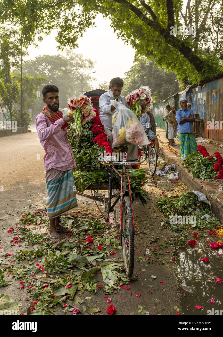 Bangladeshi men loading flowers on a rickshaw, Dhaka Division, Dhaka ...