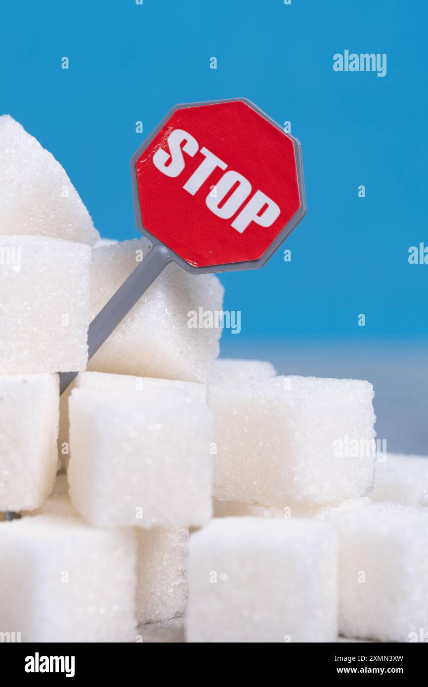 Sugar cubes and stop sign on blue background, conceptual image Stock ...
