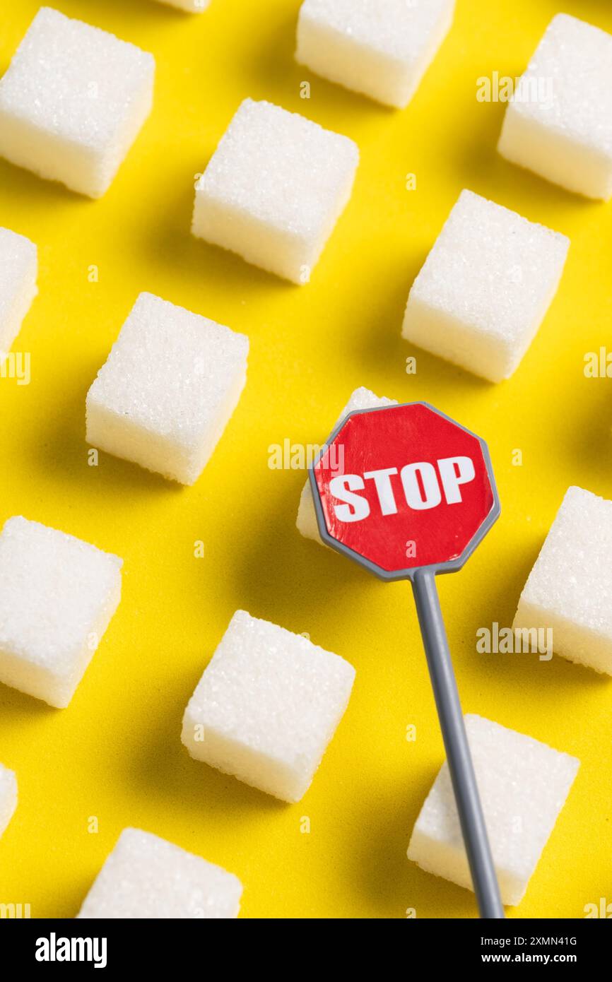 Sugar cubes and stop sign on yellow background. Conceptual image Stock ...