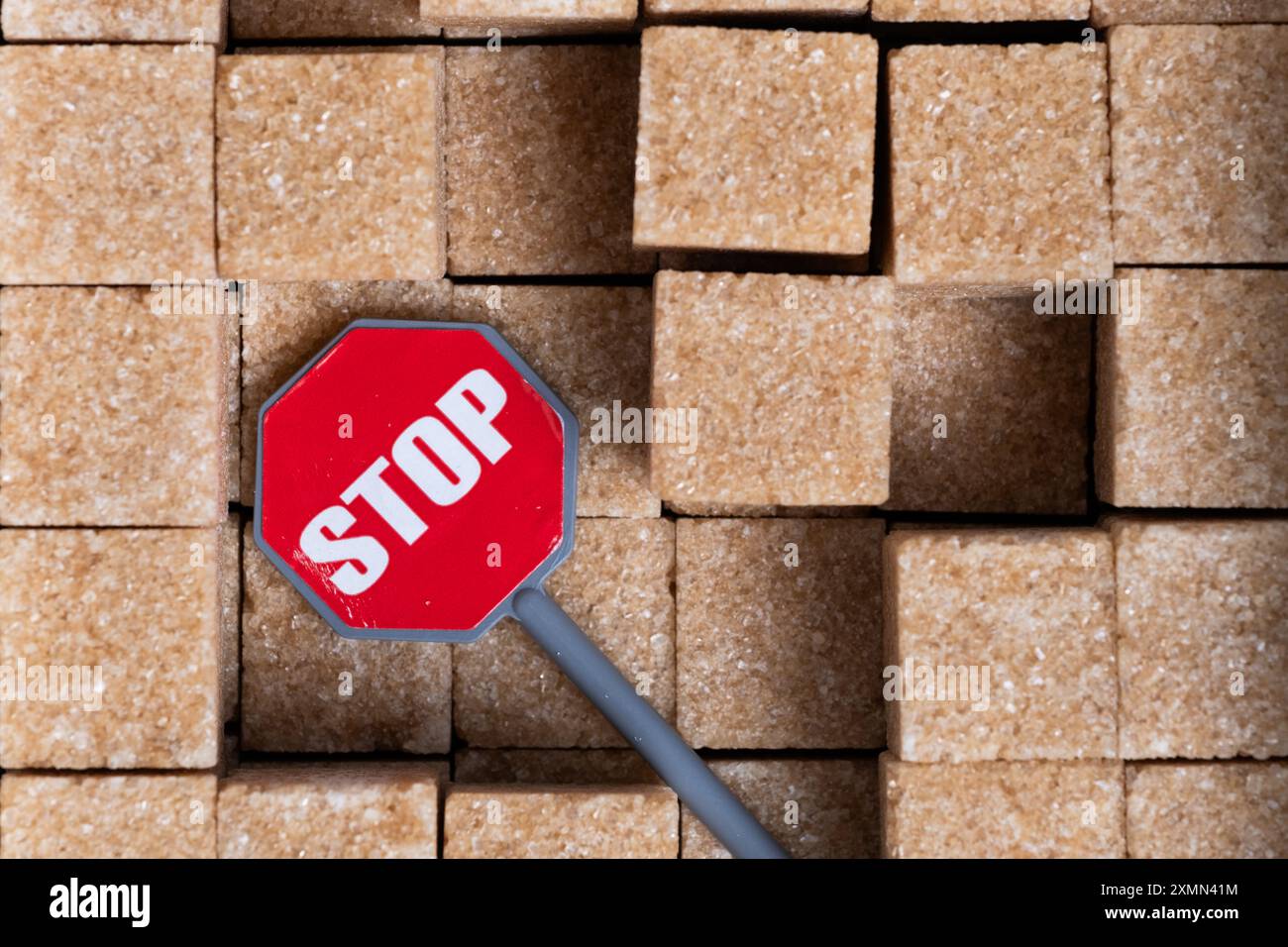 Stop sign on background of brown sugar cubes. Concept of stopping sugar ...
