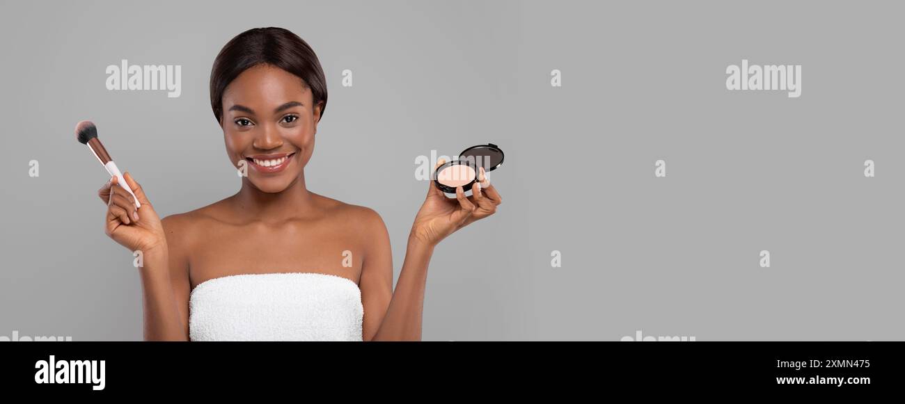 Happy pretty black lady with perfect skin do basic makeup Stock Photo ...