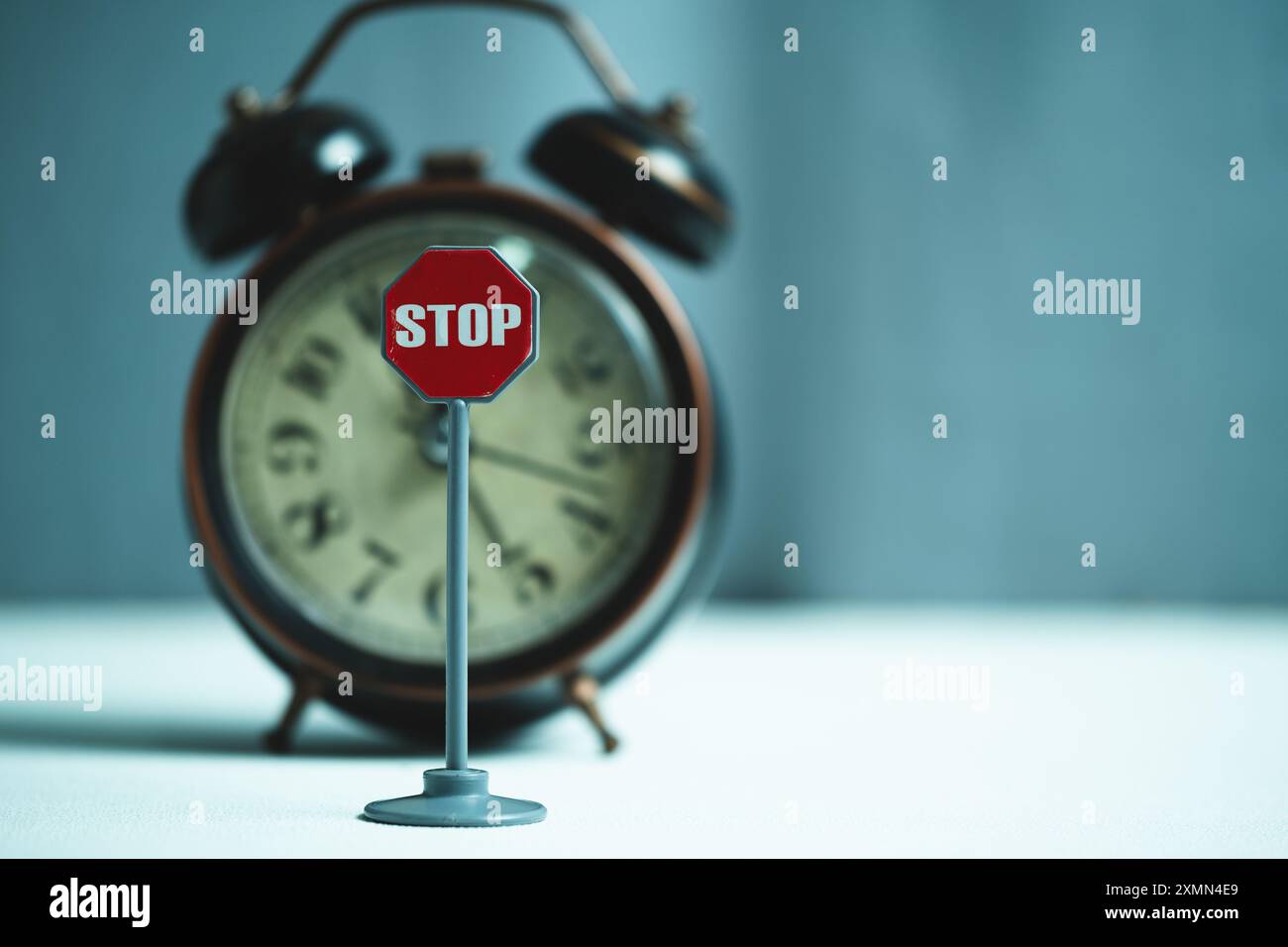 Stop sign and alarm clock on the table. Time management concept Stock ...