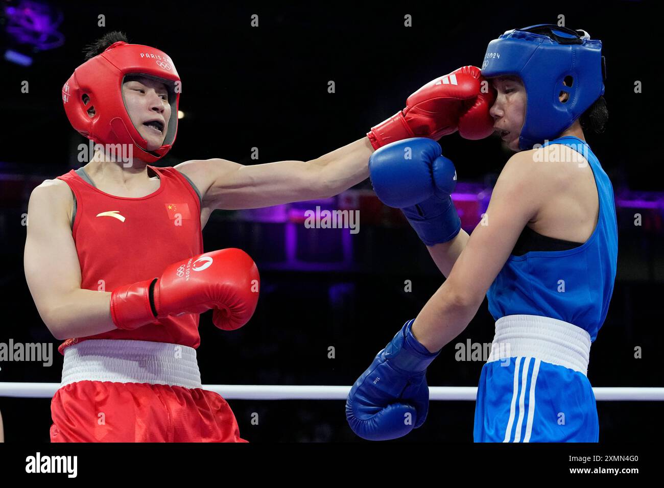 China's Yang Wenlu hits Vietnam's Thi Linh Ha in their women's 60 kg ...