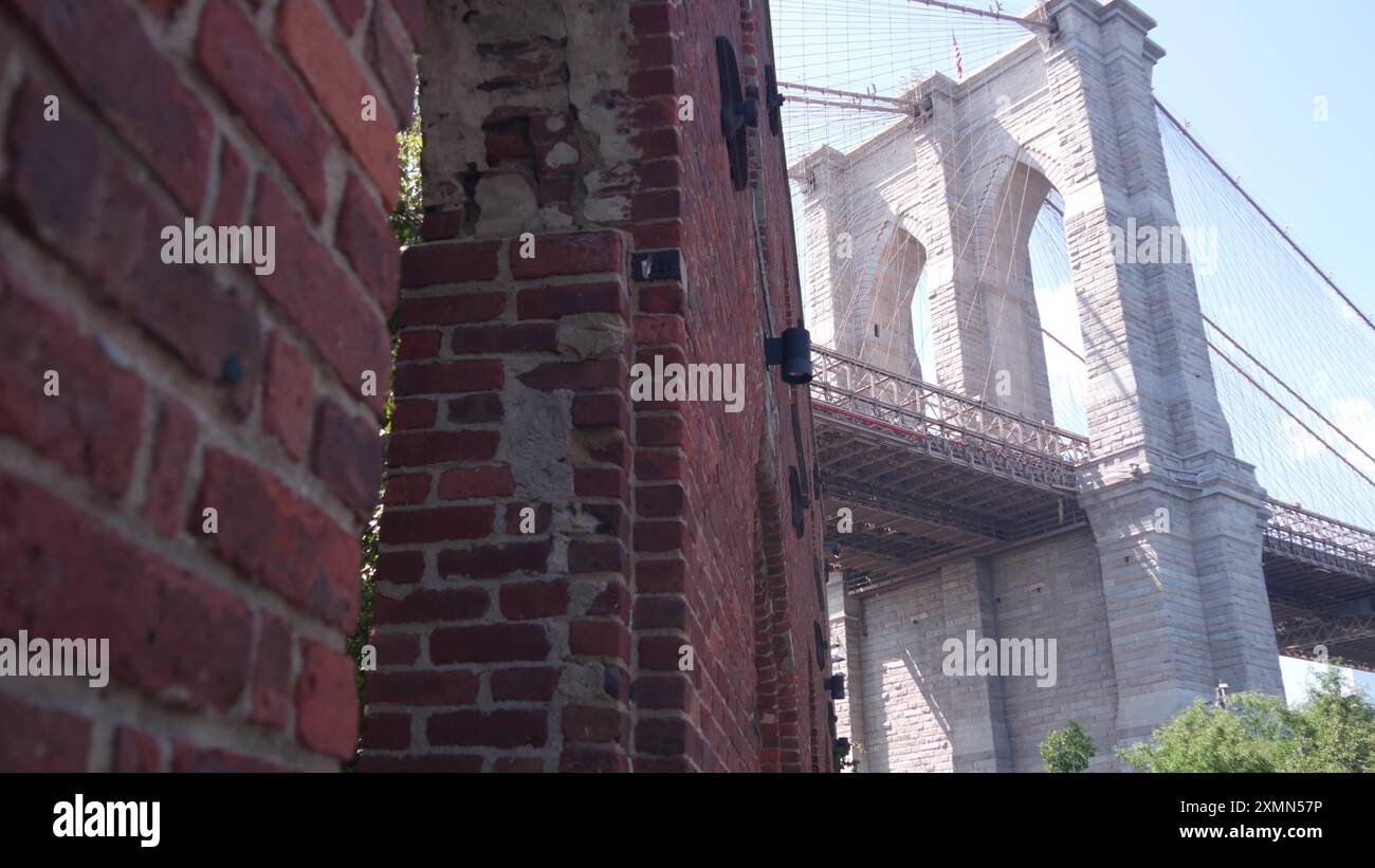 New York City Brooklyn Bridge from Dumbo. Red brick wall, old historic ...