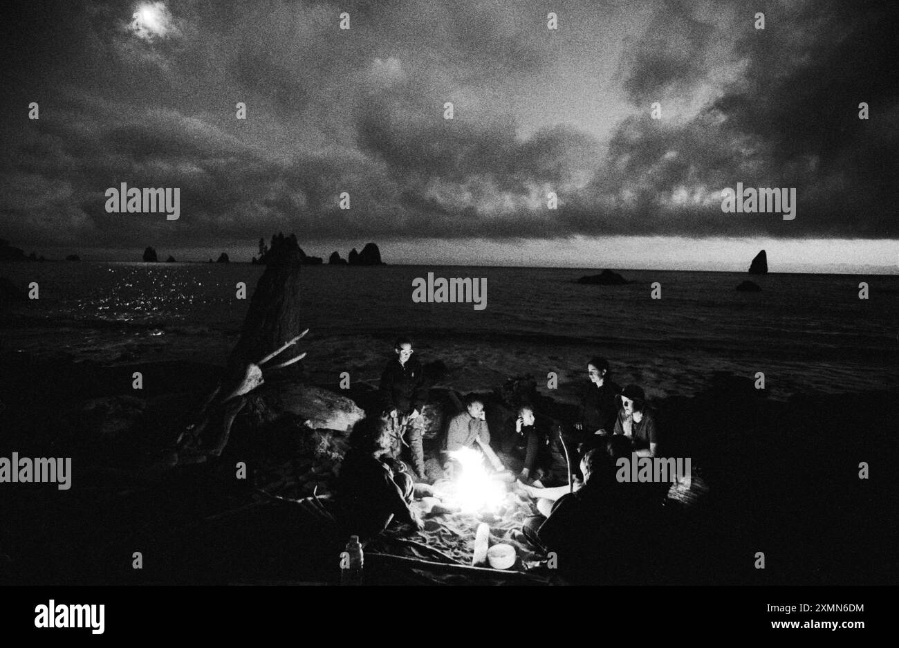 Teenage girls encircle the campfire at night Stock Photo - Alamy