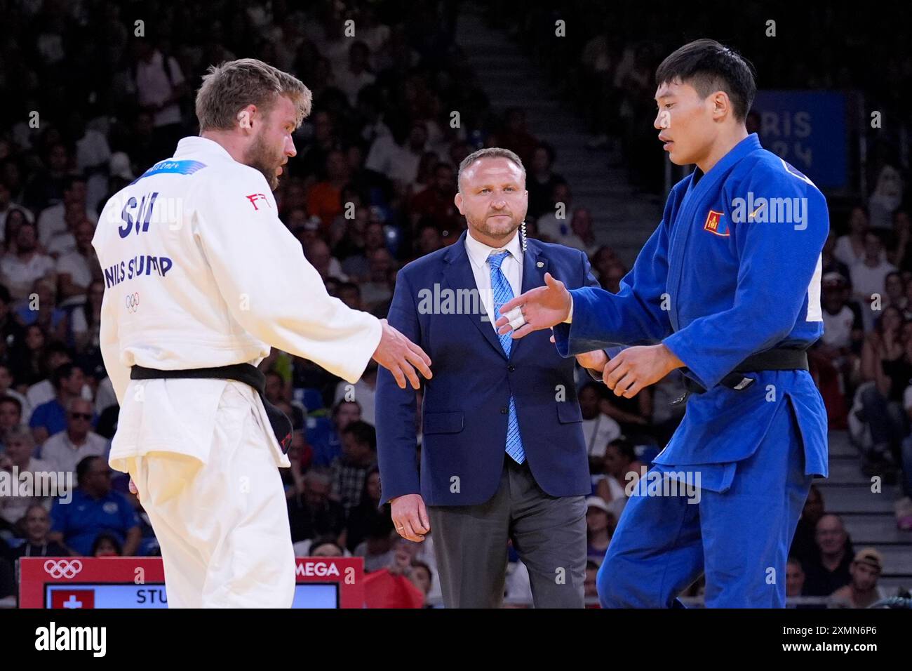 Switzerland's Nils Stump and Mongolia's Erdenebayar Batzaya shake hands ...