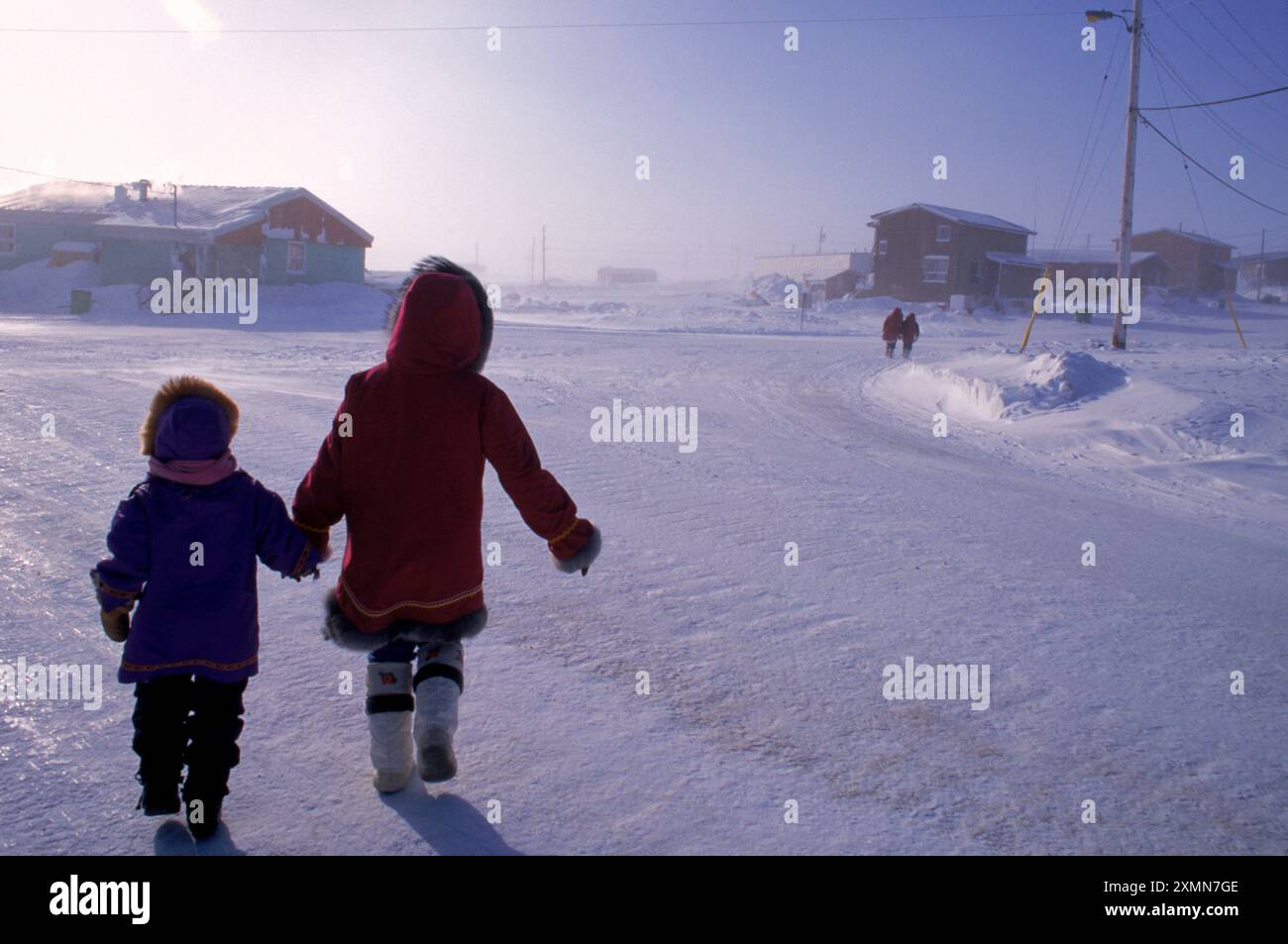 Pedestrians walk the streets of Igloolik, Nunavut, Canada Stock Photo ...