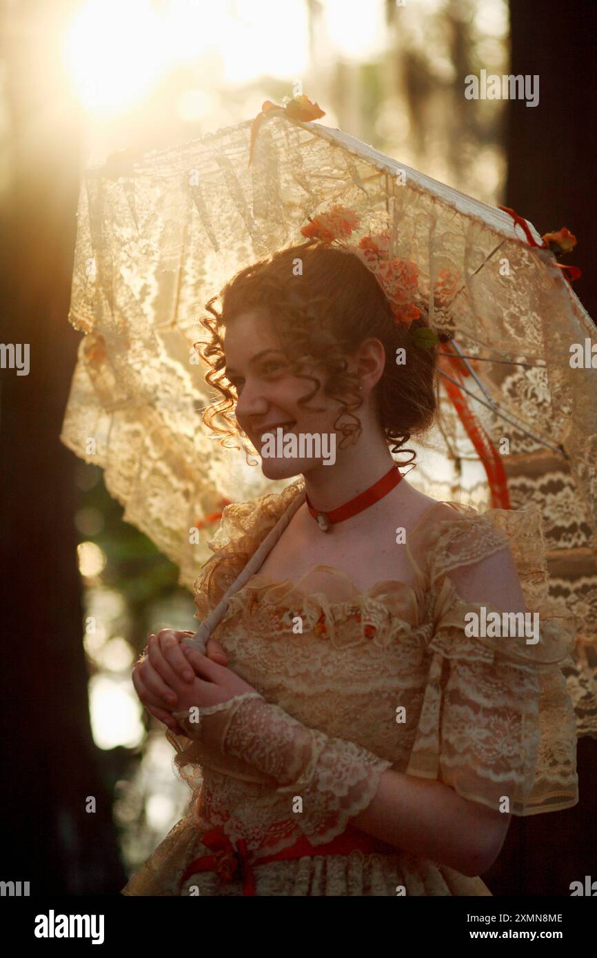 A young woman poses in a Southern Belle outfit , including a large ...