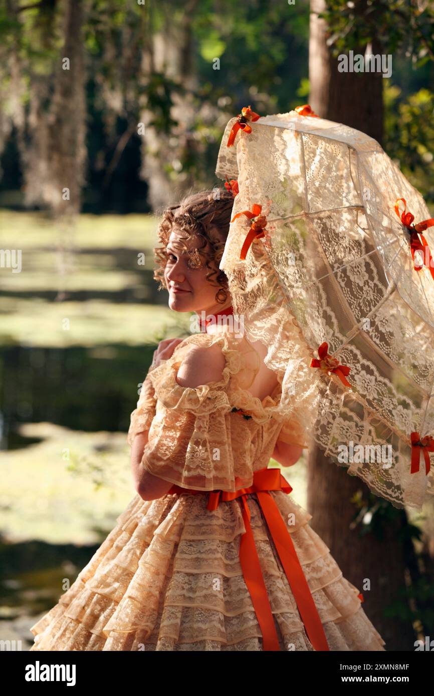 A young woman poses in a Southern Belle outfit , including a large ...