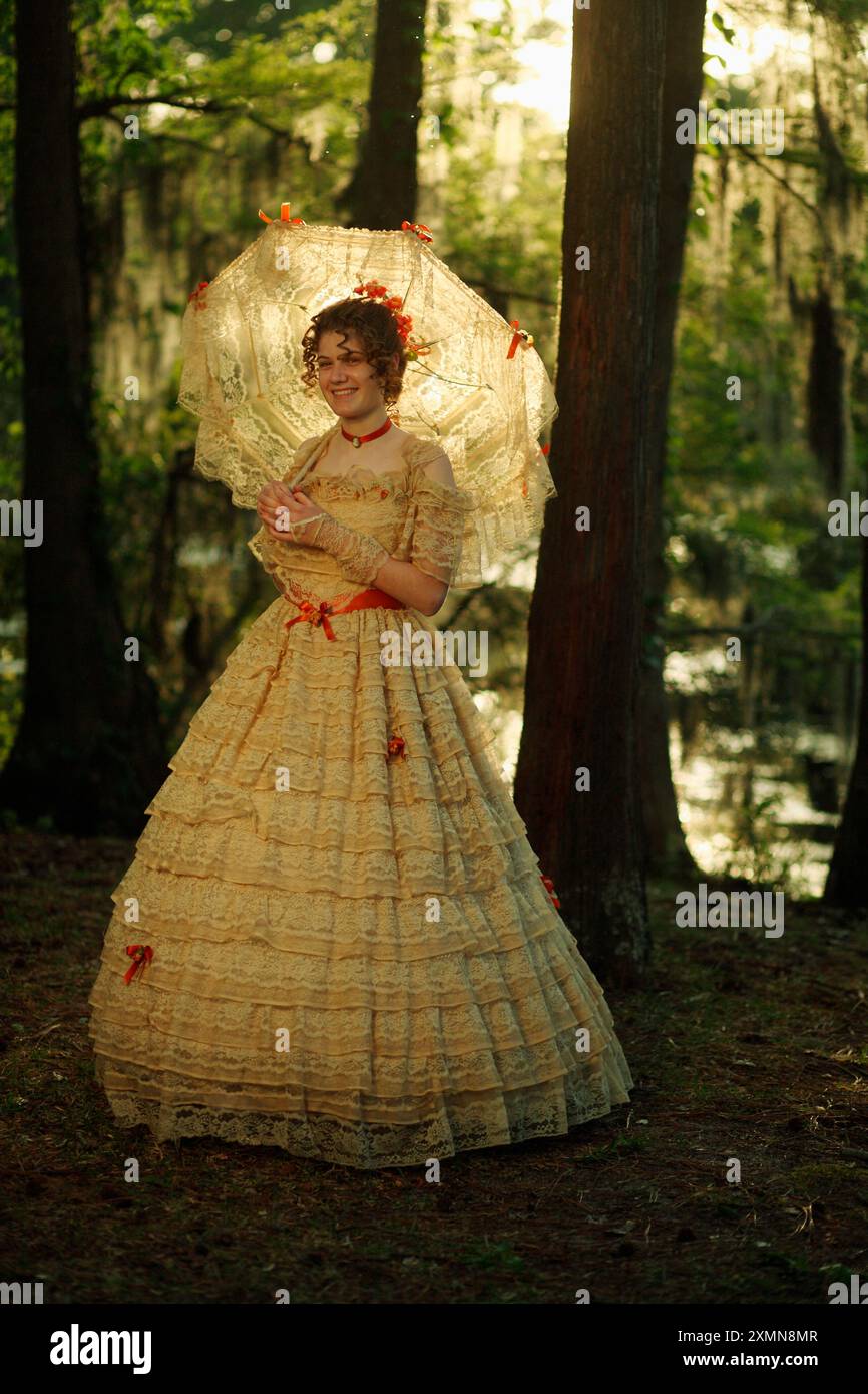 A young woman poses in a Southern Belle outfit , including a large ...