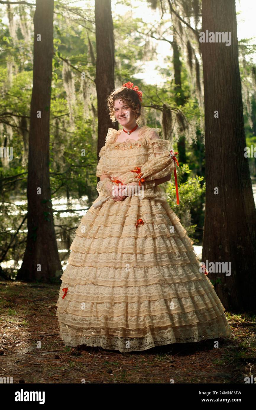 A young woman poses in a Southern Belle outfit , including a large ...