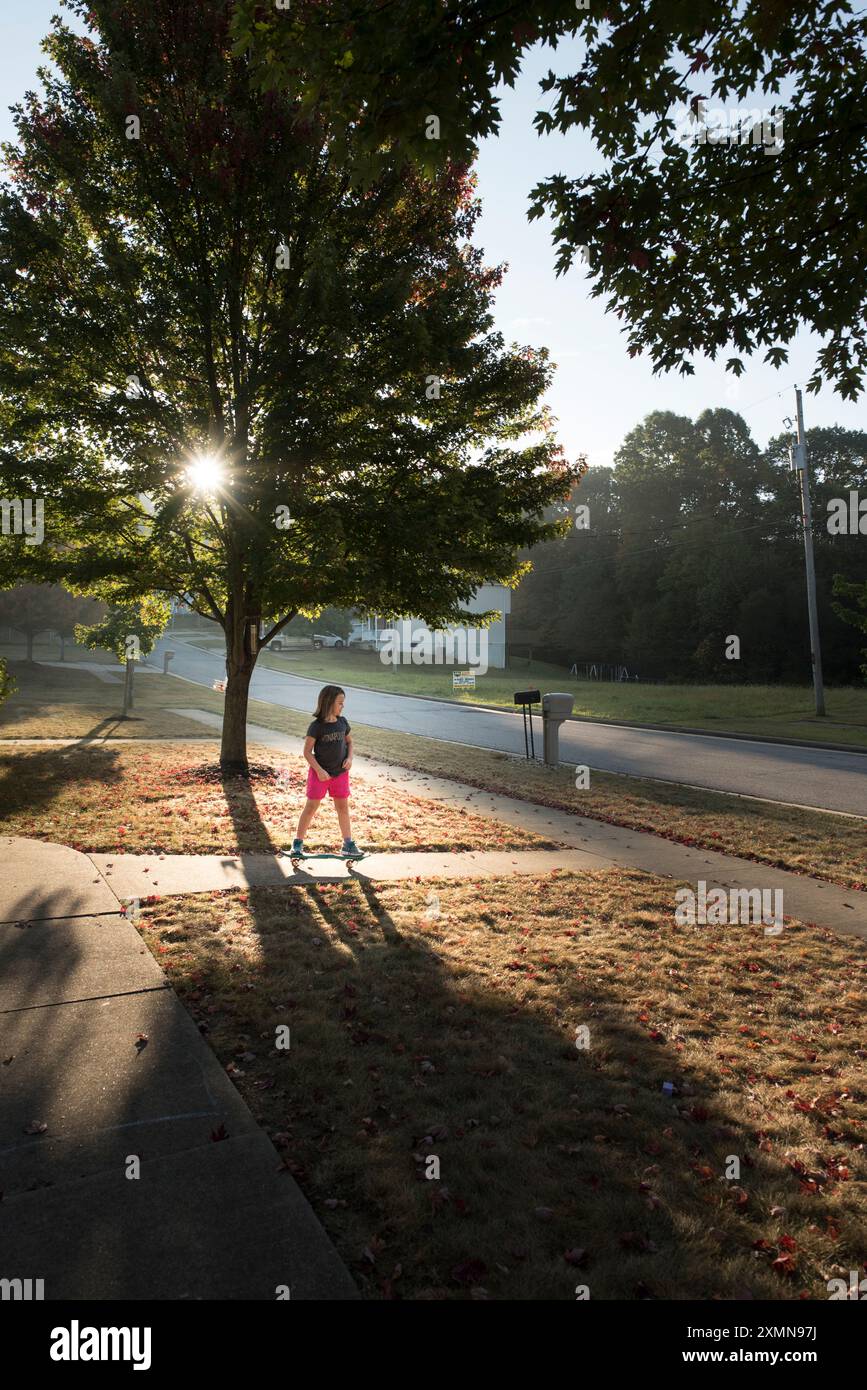 Young girl on skateboard sunny fall day Stock Photo - Alamy