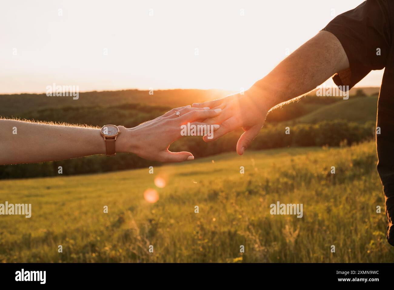 Romantic Sunset Hand in Hand Stock Photo - Alamy