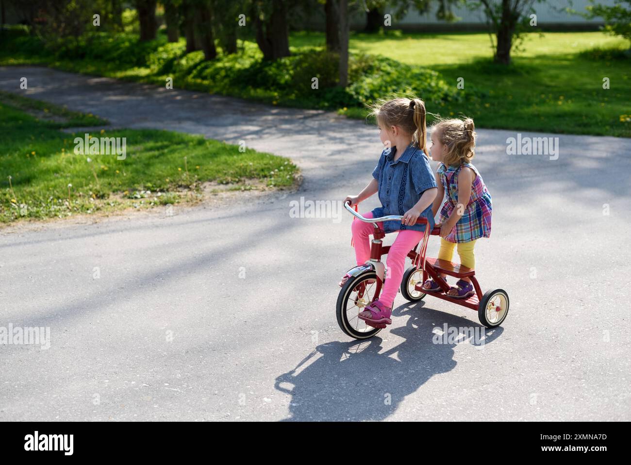 Happy child riding tricycle hi-res stock photography and images - Alamy